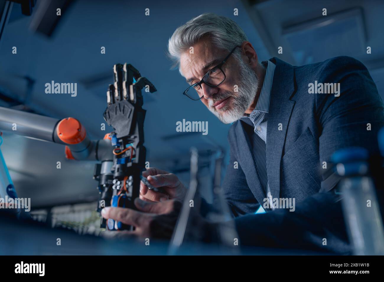 Robotics engineer adjusting, calibring robotic prosthetic hand. Concept ...