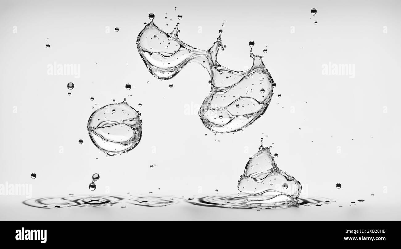 Water droplets frozen in mid-air, splash patterns against white ...
