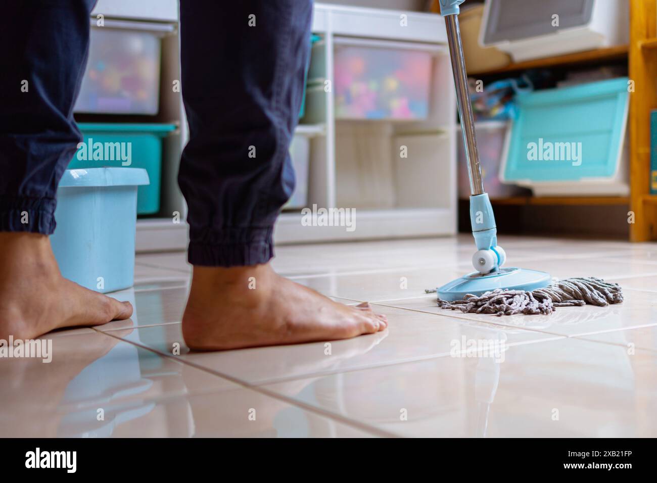 dad helping chores at home, mopping floor in the kids room Stock Photo ...