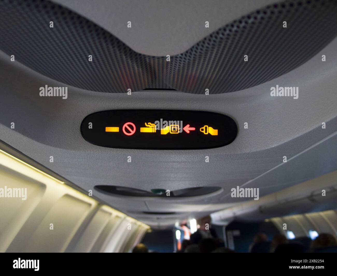 No smoking and fasten seat belts signs inside a jet airplane Stock ...