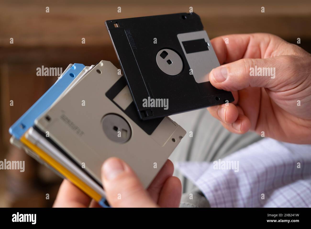 mature male hand holding vintage electronic data storage devices ...