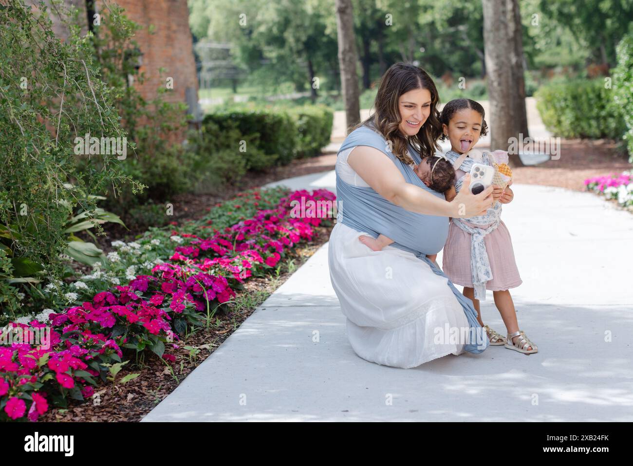 mom and daughter make silly faces outside while taking selfie Stock ...