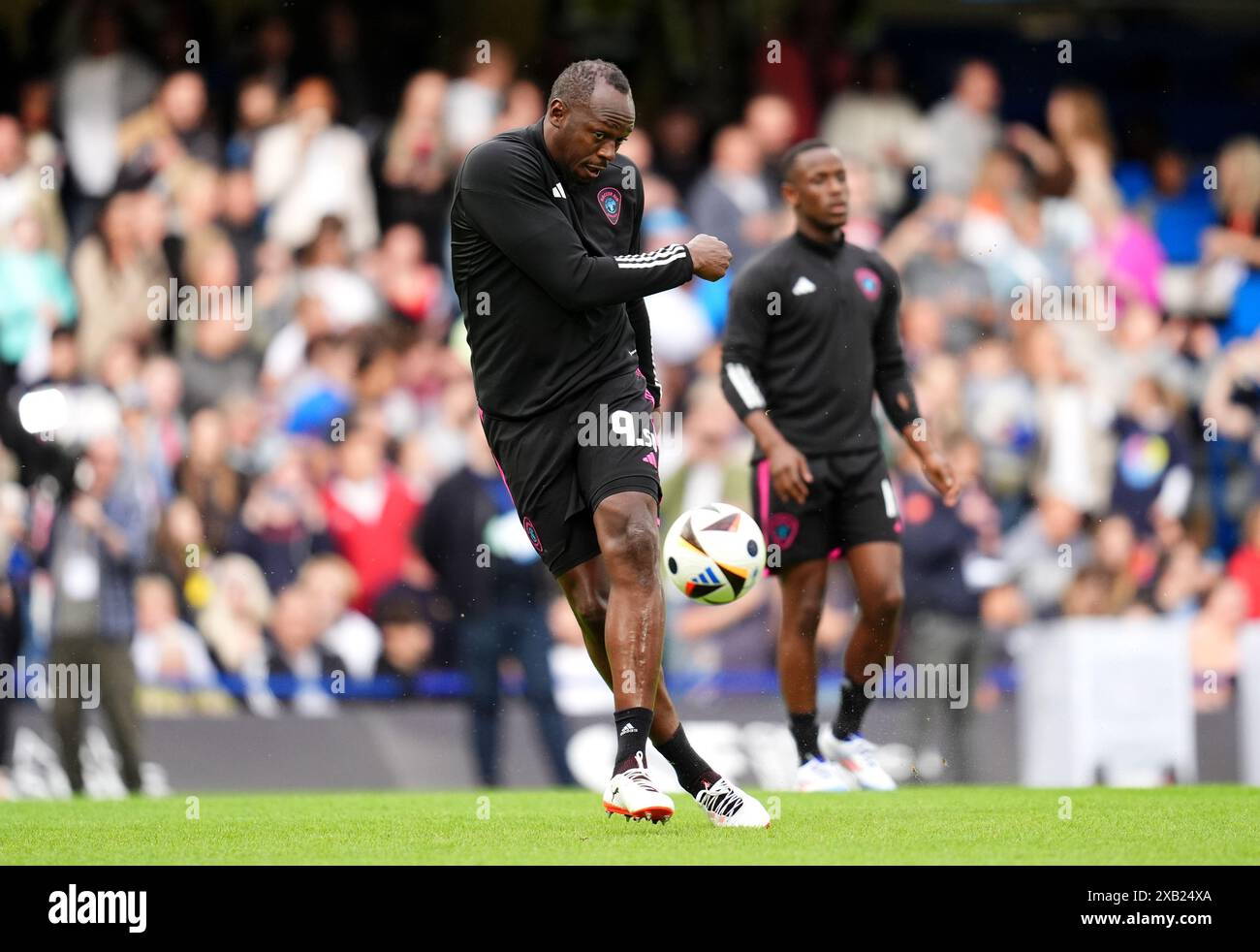 World XI's Usain Bolt (centre) warming up prior to kick-off before ...