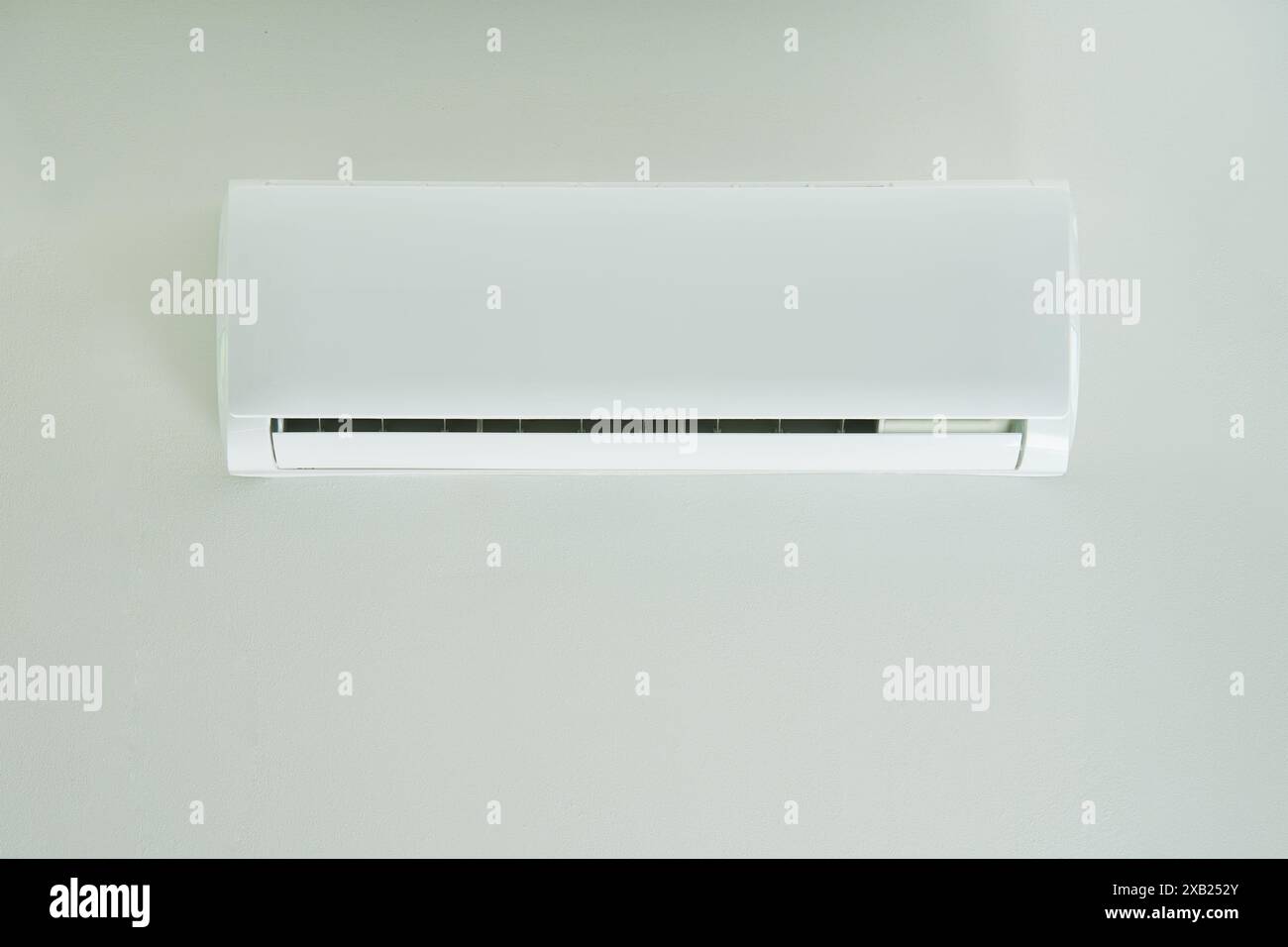 Air conditioner mounted on white wall in modern apartment. Cooling ...