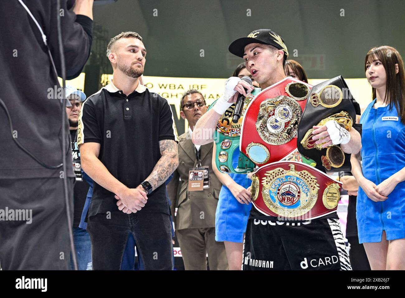 Japan's Naoya Inoue, right, stands with Australia's Sam Goodman on the ring after winning the ...
