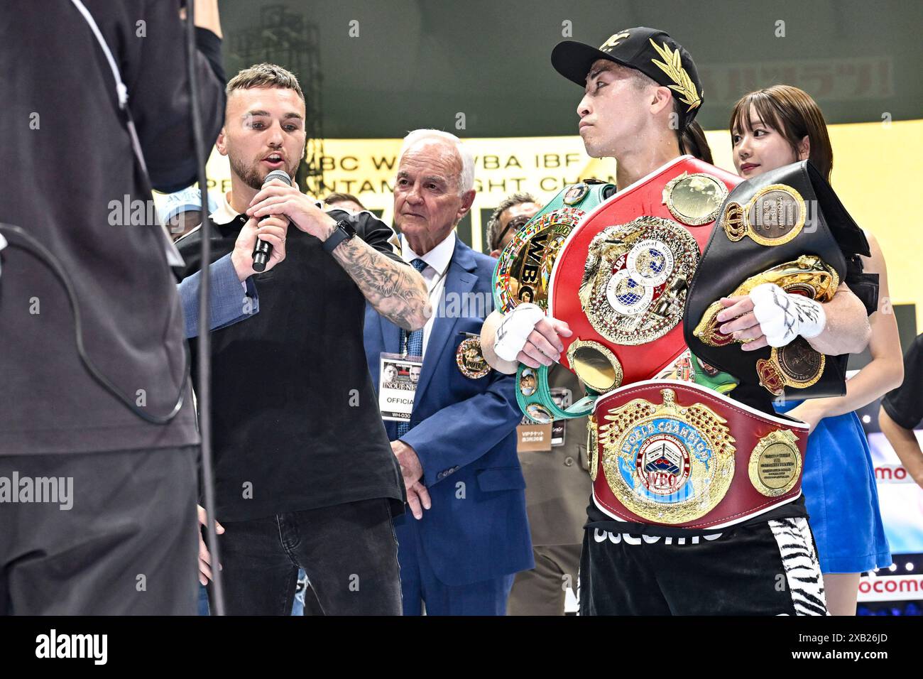 Japan's Naoya Inoue, right, stands with Australia's Sam Goodman on the ring after winning the ...