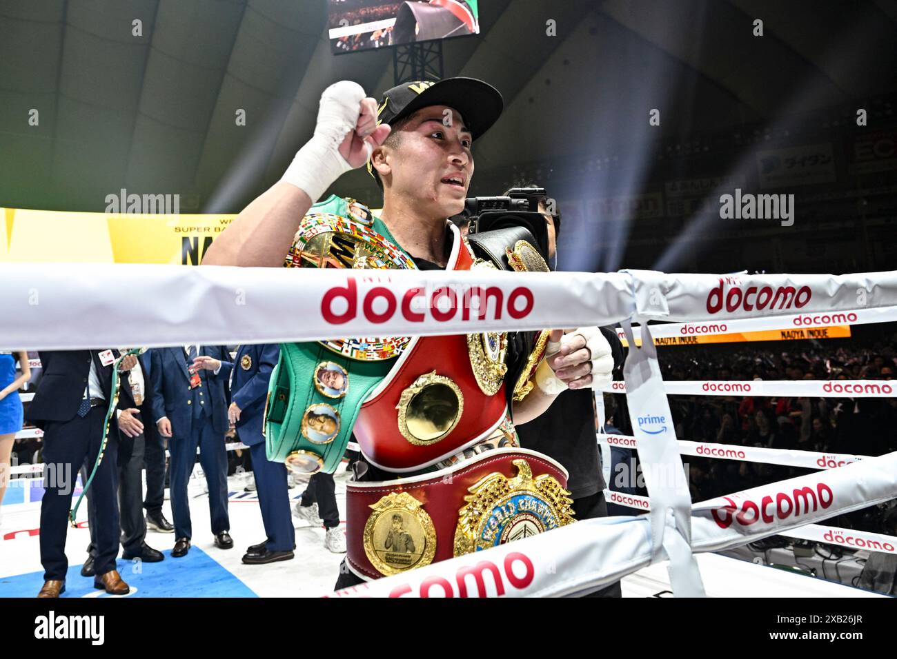 Japan's Naoya Inoue celebrates with his championship belts after ...