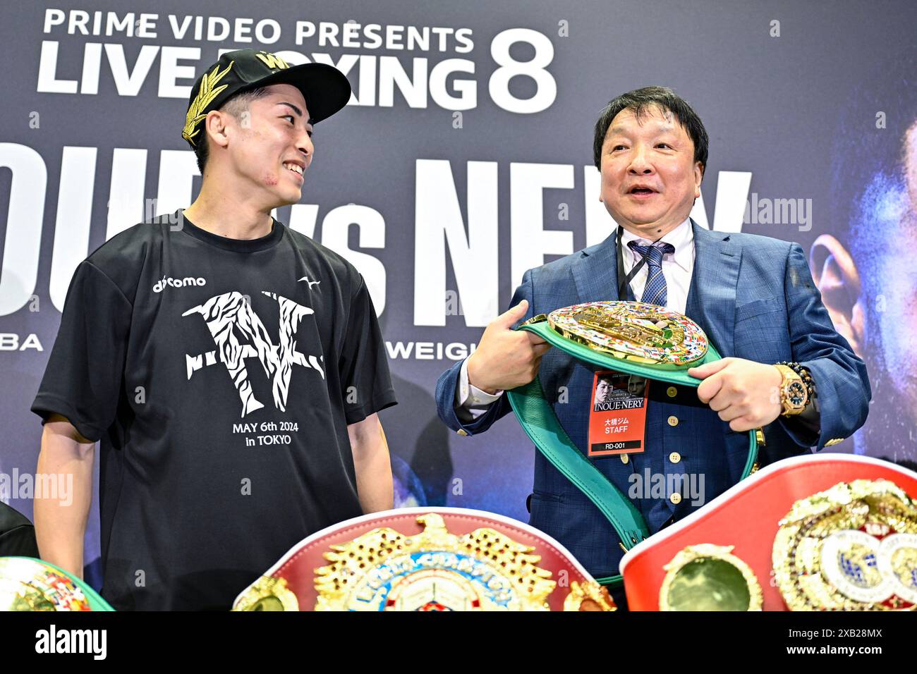 Japan's Naoya Inoue, left, gives his WBC Diamond Championship belt to Ohhashi Boxing Gym ...