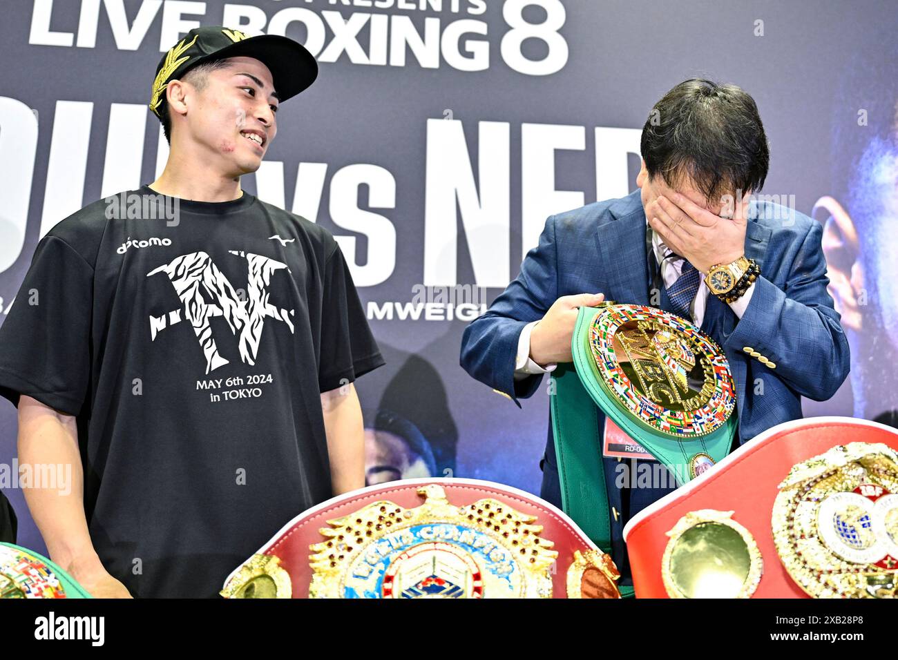 Japan's Naoya Inoue, left, gives his WBC Diamond Championship belt to Ohhashi Boxing Gym ...