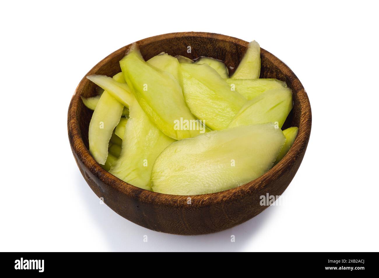 sour mango with sweet brine in a wooden bowl, isolated on white ...