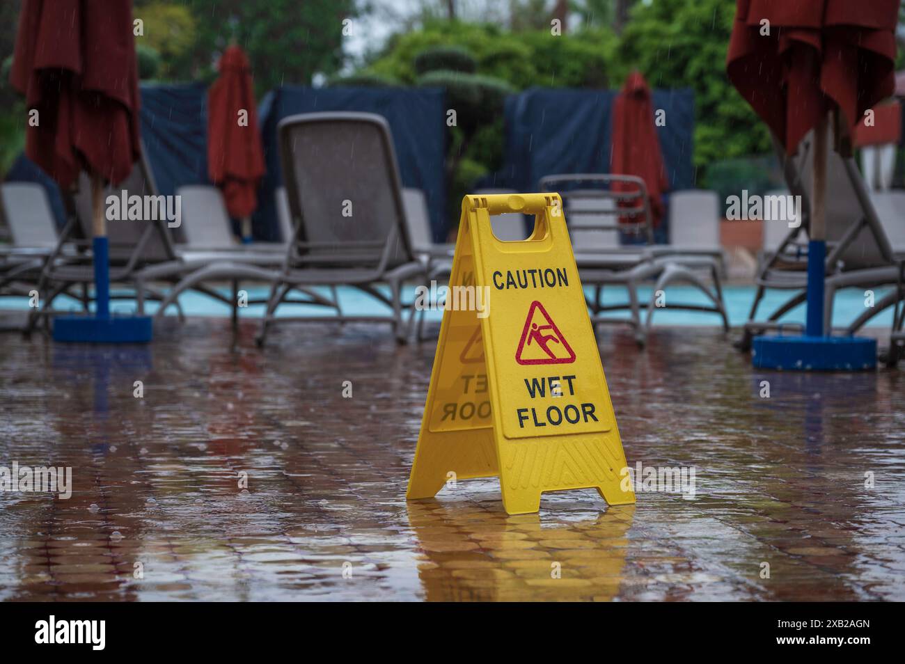 Yellow warning sign, stating "Caution Wet Floor", next to a hotel ...