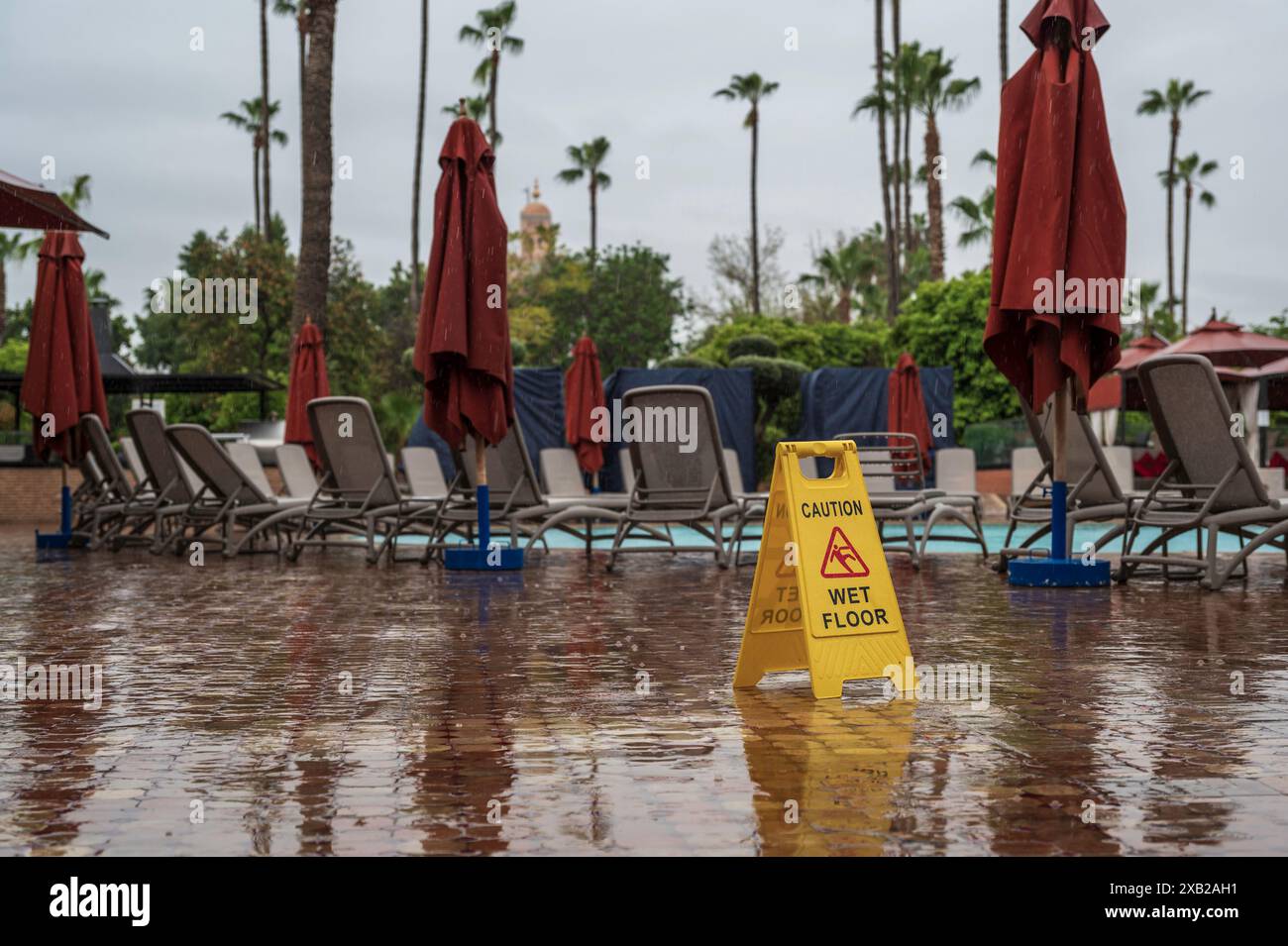 Yellow warning sign, stating "Caution Wet Floor", next to a hotel ...