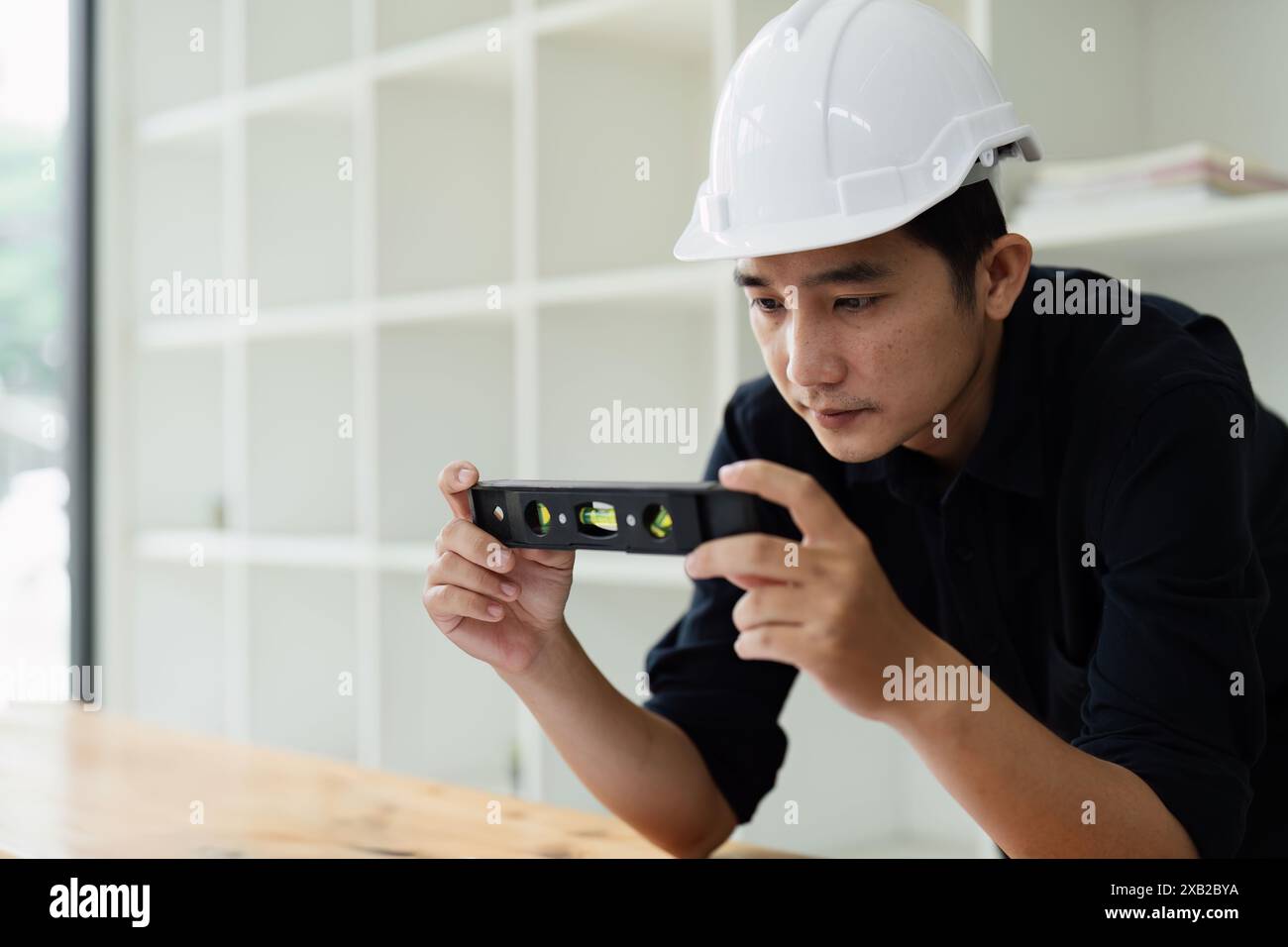 Focused Construction Worker Using a Level Tool for Precision ...