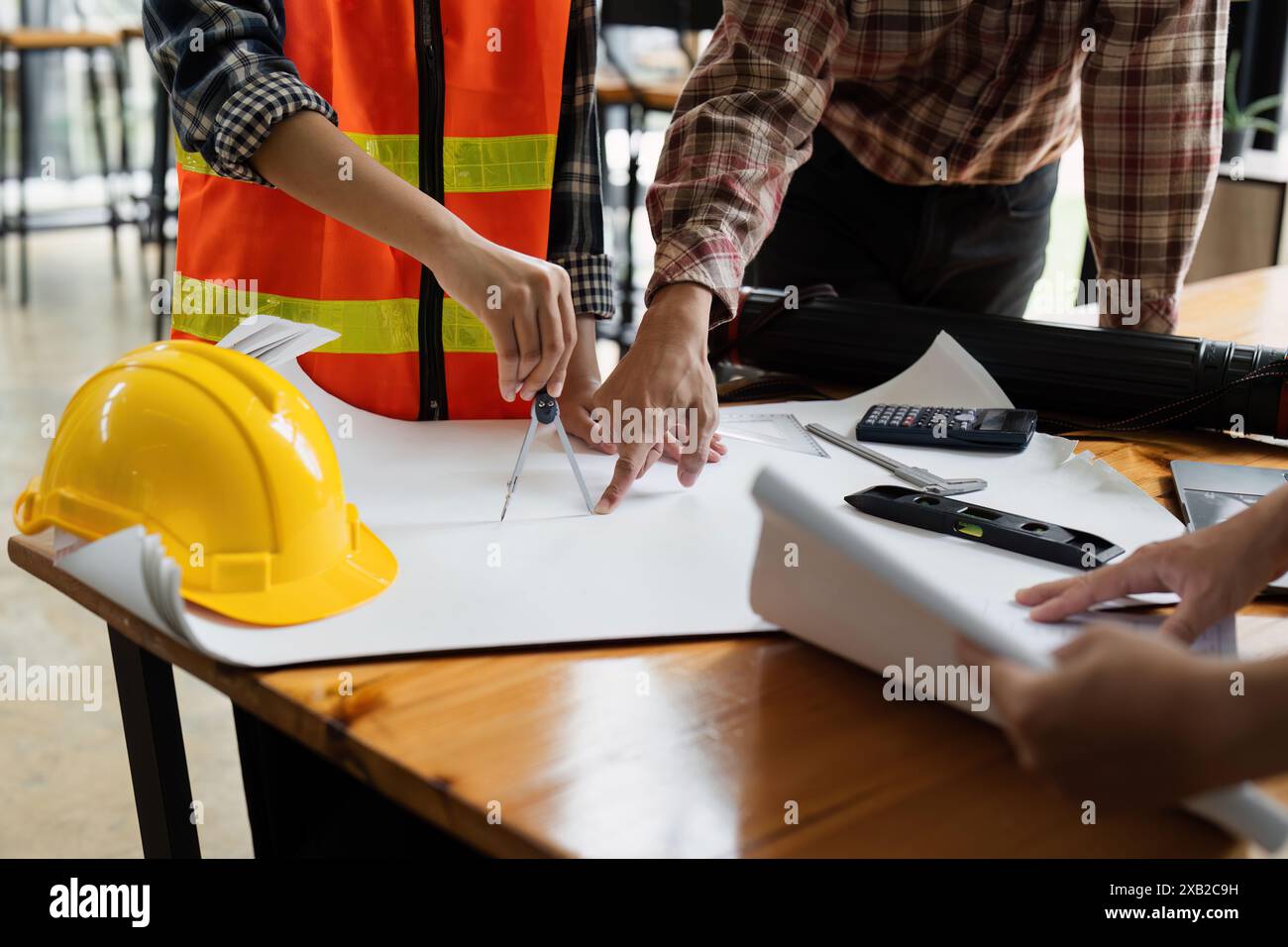 Architects Collaborating on Construction Project with Blueprints and ...
