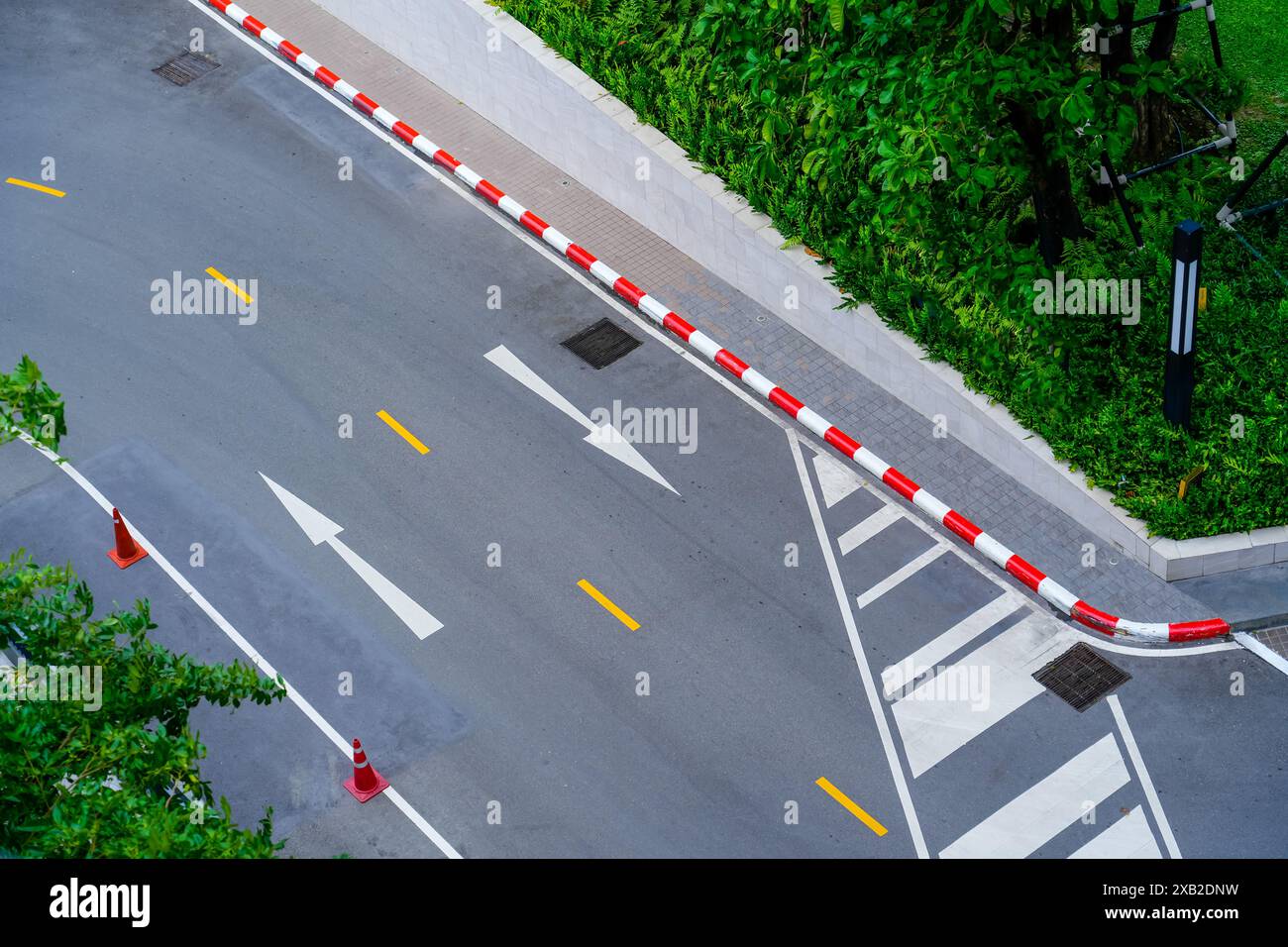 Driveway of an inner yard road with a rosette and a bright striped curb ...