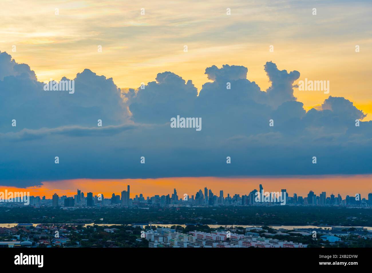 Sunrise over modern buildings in district center. Heavy cumulus before ...