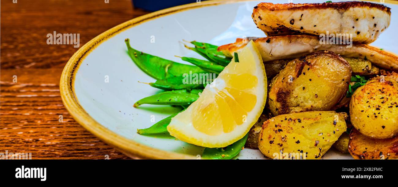 Pan fried sea bass Stock Photo - Alamy