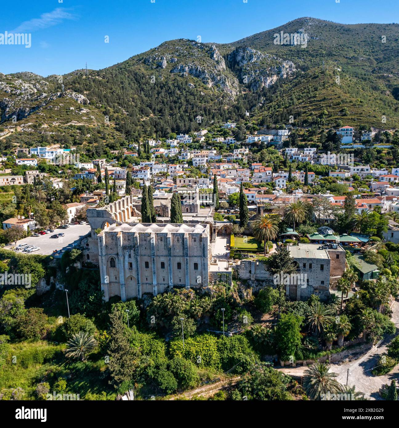 Medieval gothic Bellapais Abbey surrounded by village houses. Kyrenia ...