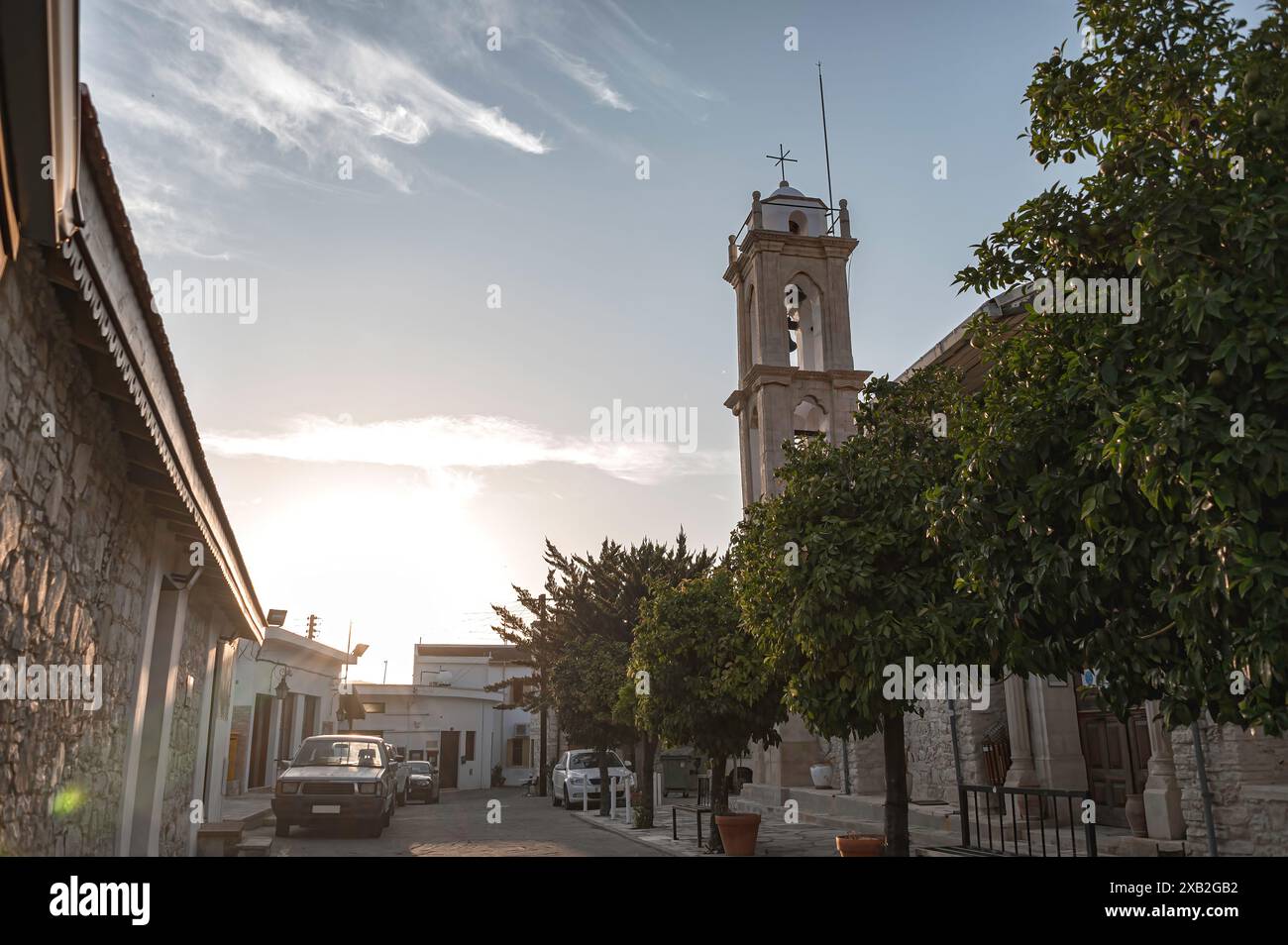 Tranquil sunset scene with a charming church bell tower rising against ...
