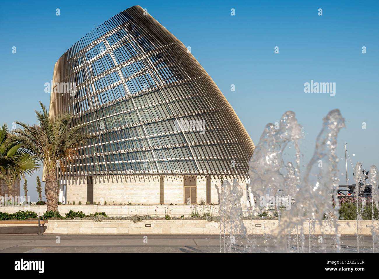 Contemporary building with unique facade behind a playful water ...