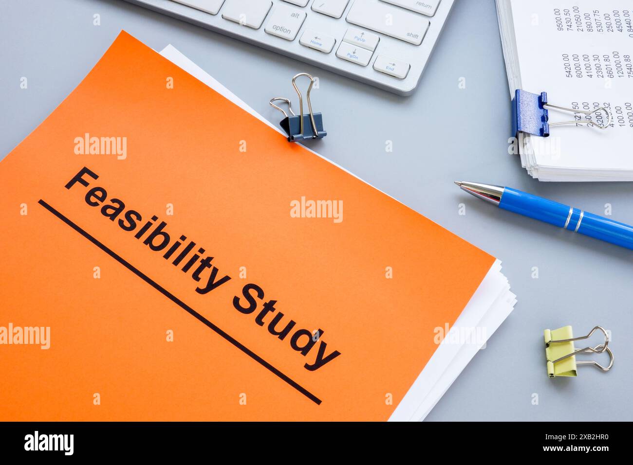 Stack of papers with feasibility study and keyboard Stock Photo - Alamy