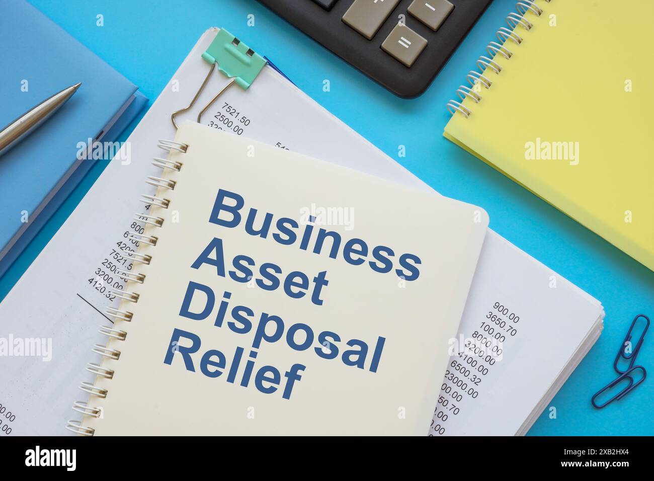 Stack of financial papers and book business asset disposal relief Stock ...