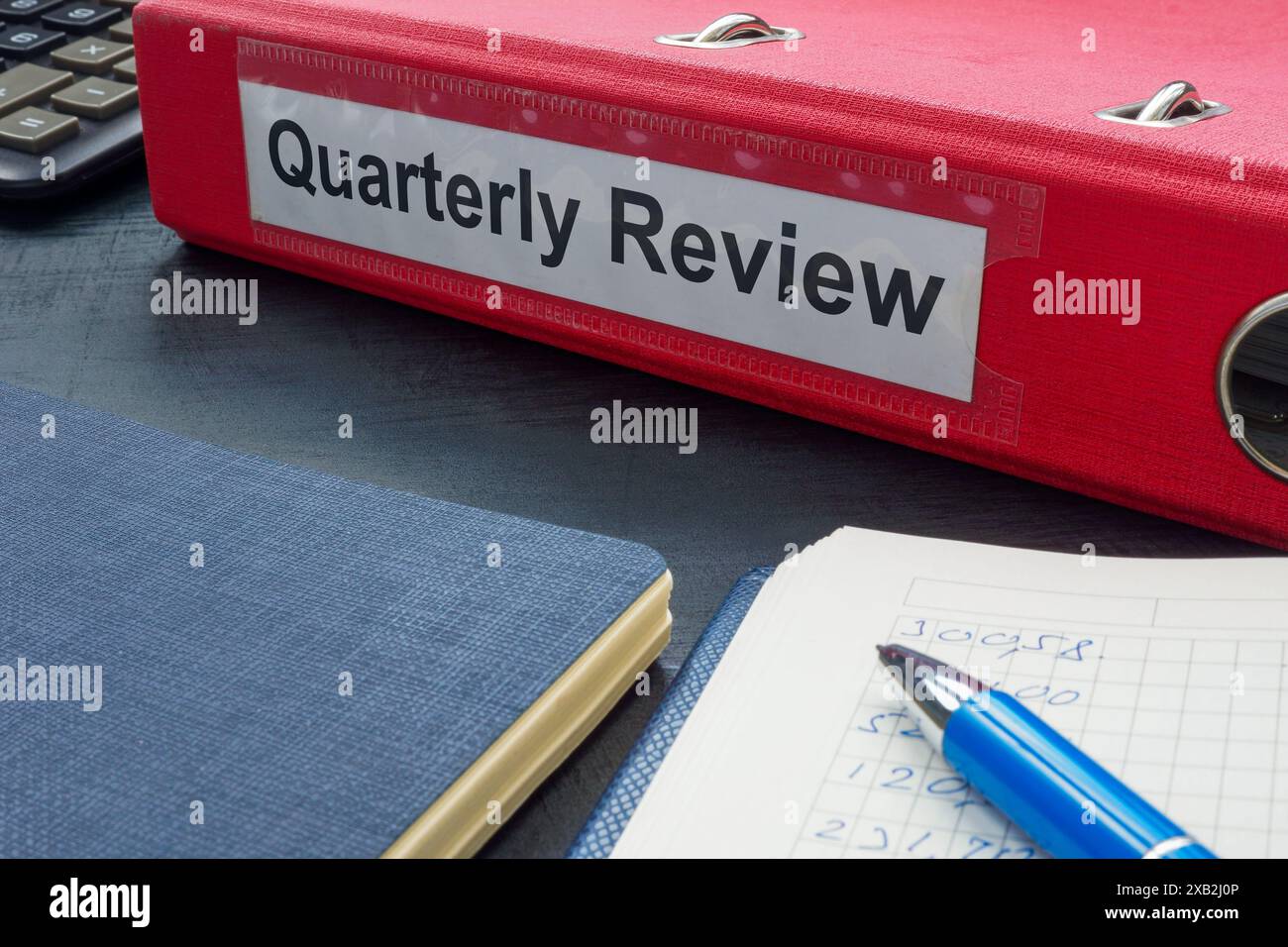 Folder with label quarterly review and papers Stock Photo - Alamy