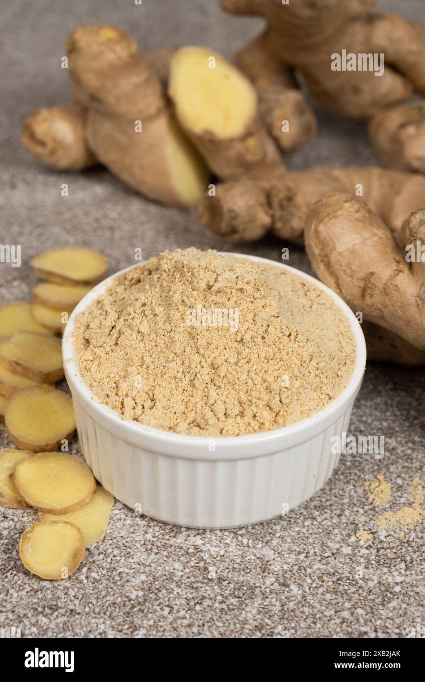Ground ginger root powder natural spice seasoning on gray stone ...