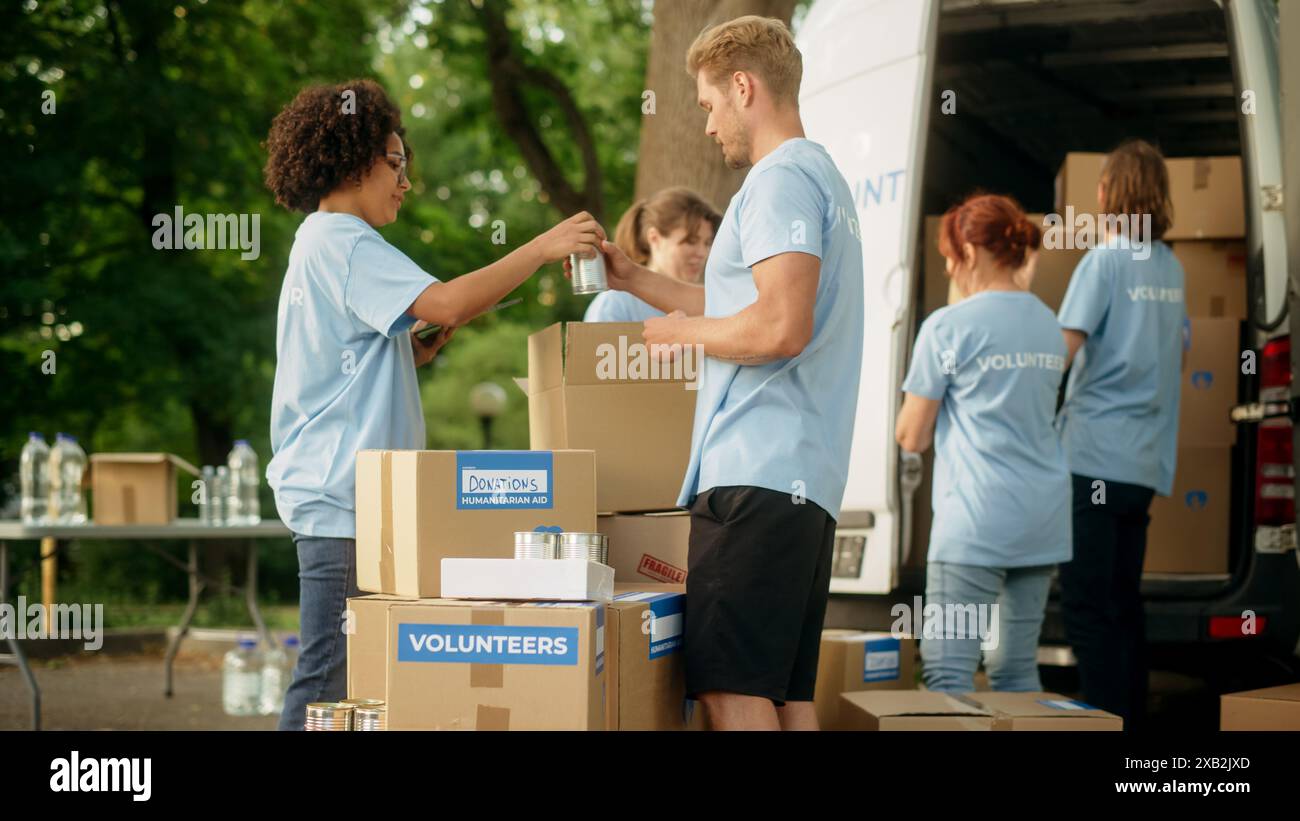 Positive Group of Young Adult Volunteers Loading Food Rations and Humanitarian Donations for ...