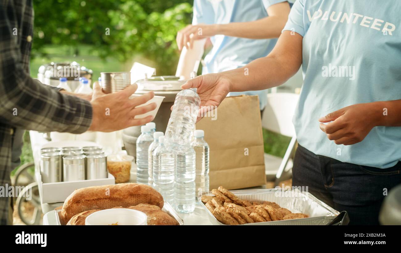 Close Up of an Anonymous Person Handing Over a Water Bottle to Another ...
