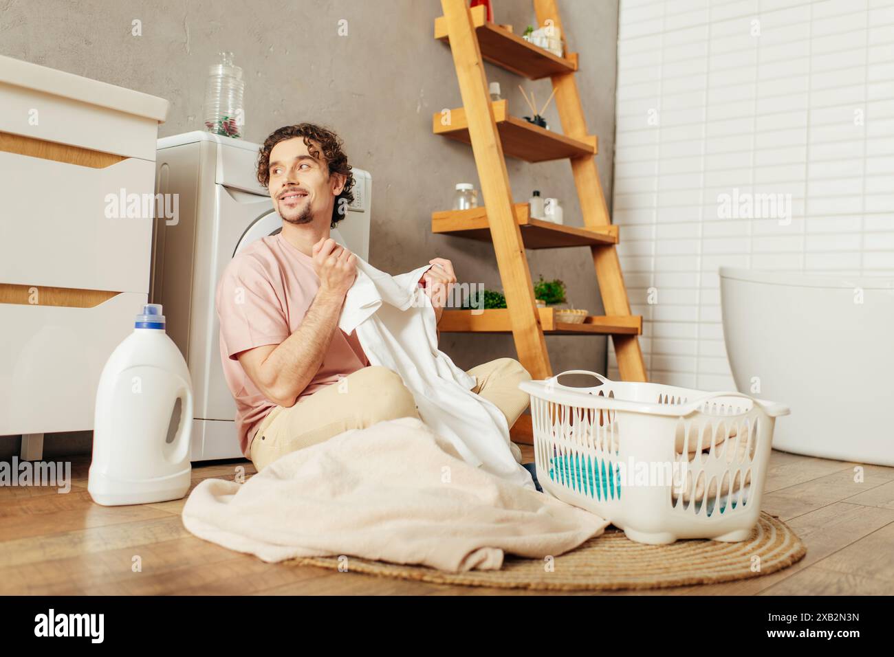 Man folding laundry hi-res stock photography and images - Alamy