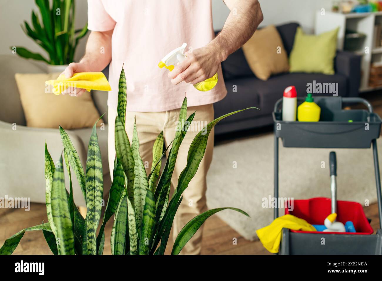 A handsome man in cozy homewear cleaning his house with care Stock ...