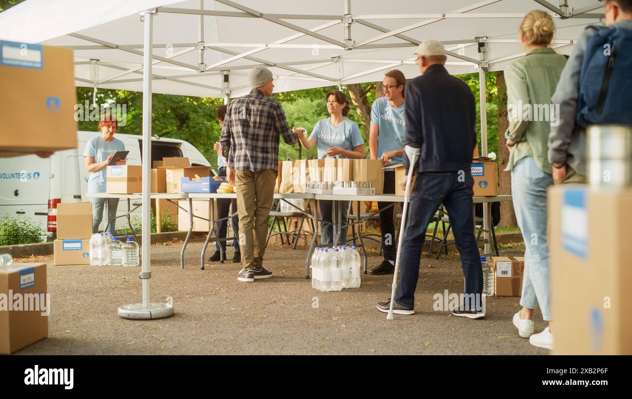 Establishing Shot of a Group of Volunteers Handing Out Food Rations for ...