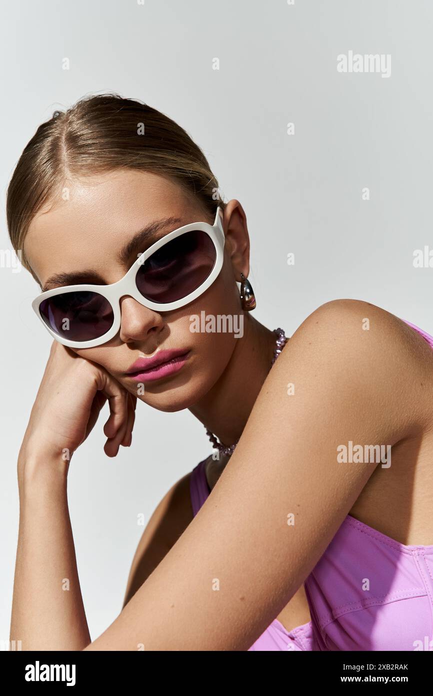 Blonde woman looking fashionable in pink swimsuit and sunglasses Stock ...