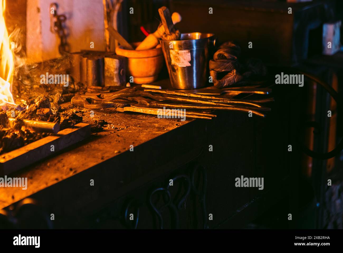 A warm, glowing scene at a traditional blacksmith's forge, highlighting ...