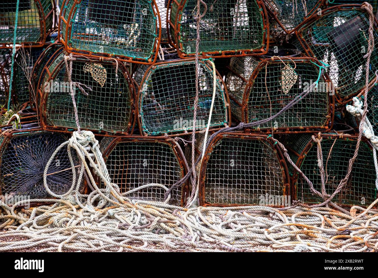Piles of rusty lobster pots entangled with heavy ropes at the ...