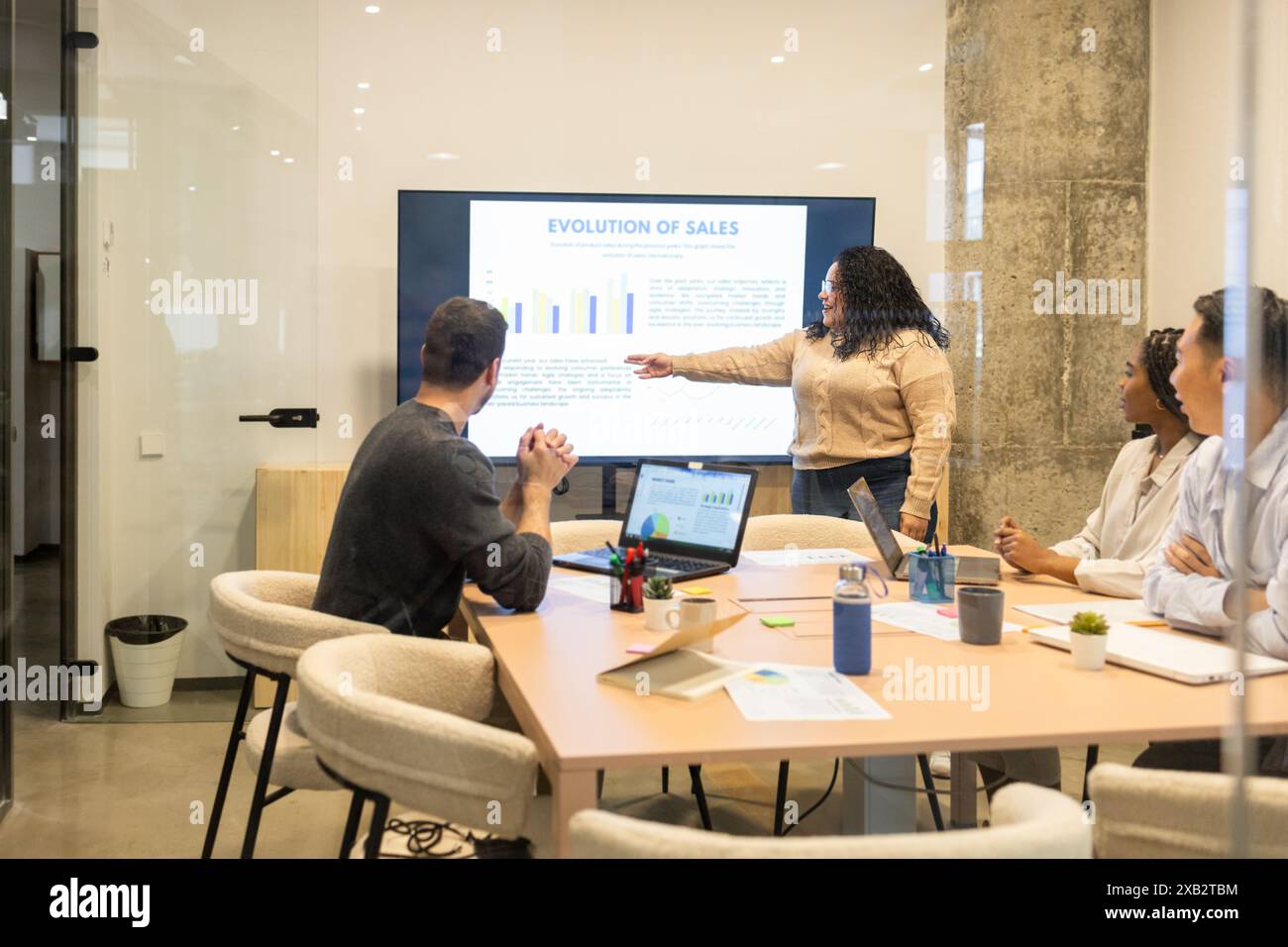 A diverse team engages in a productive meeting as one member presents a ...