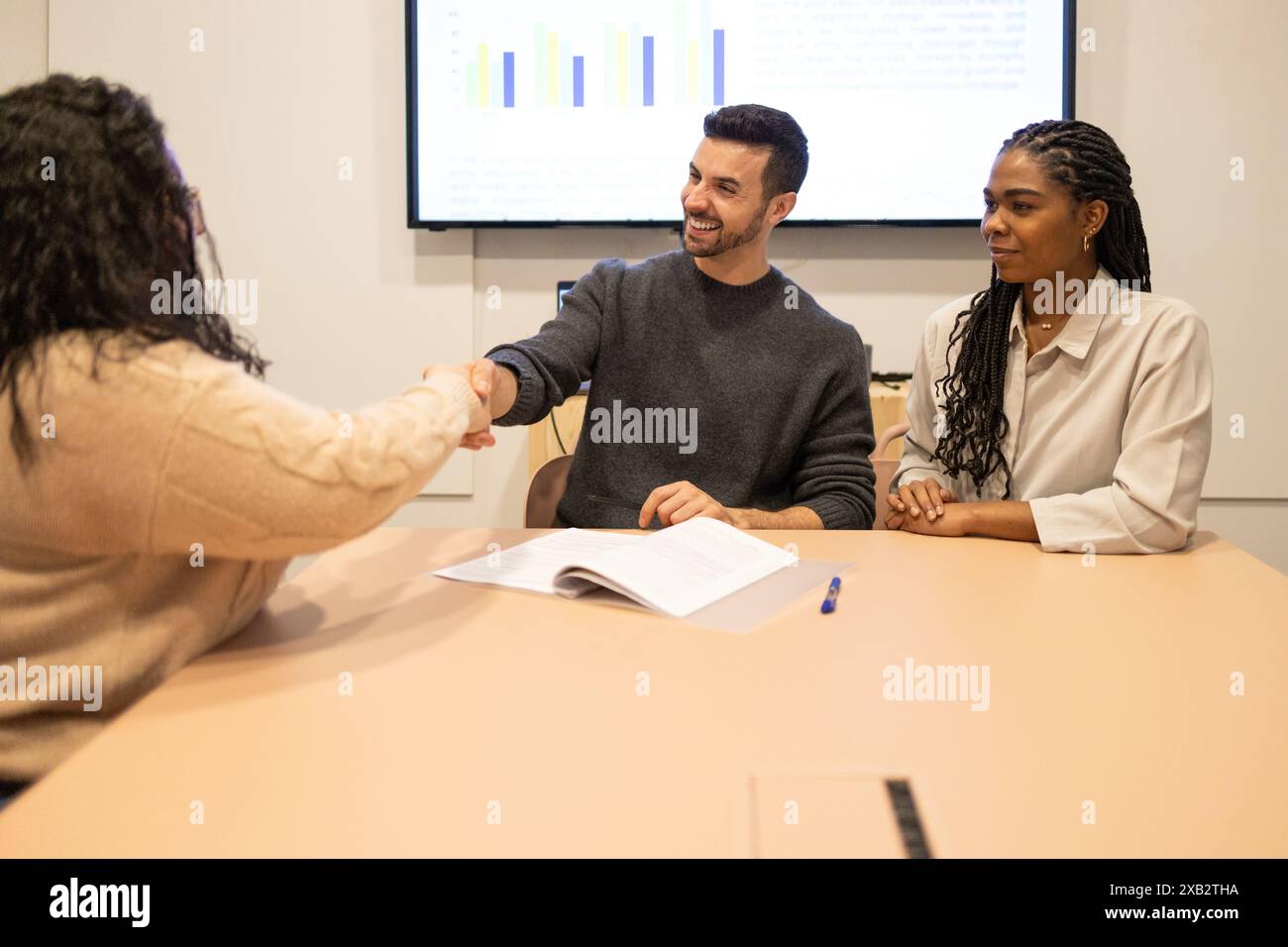 A diverse team engages in a productive coworking meeting with a ...