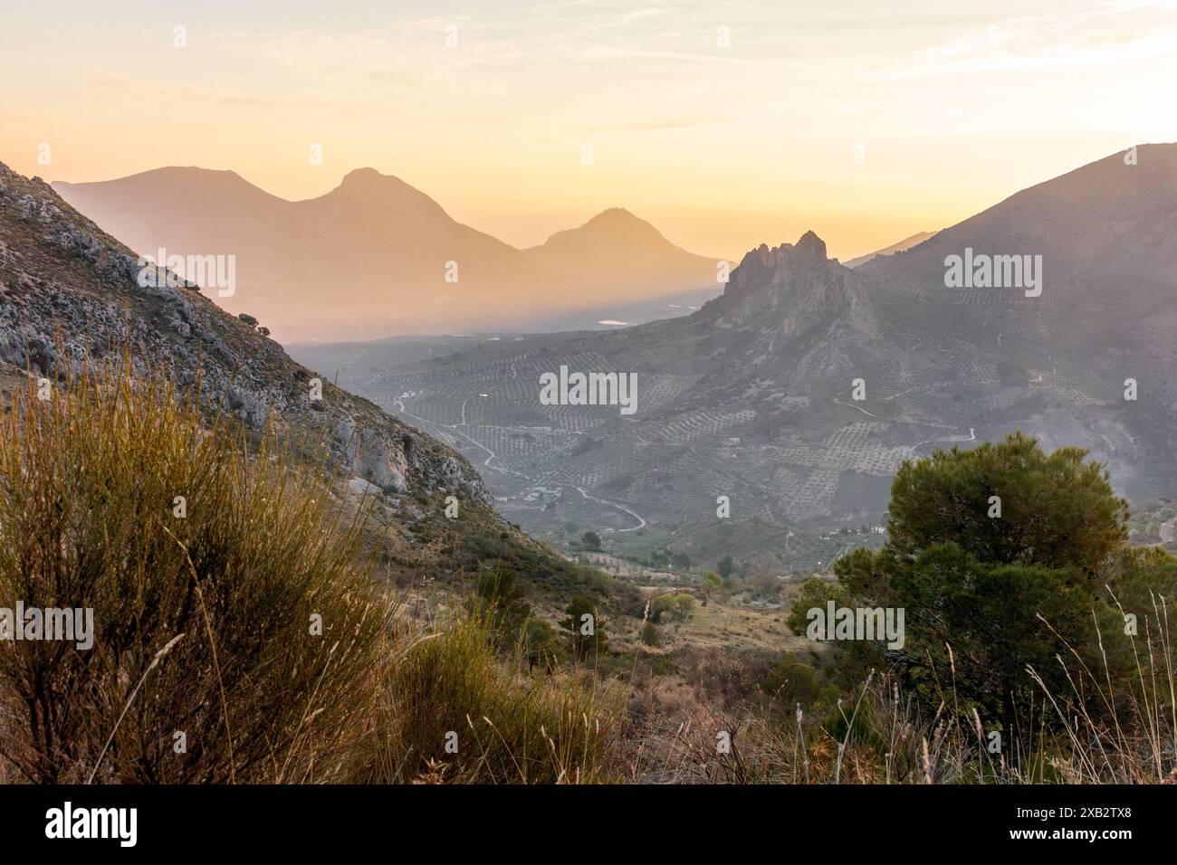 Golden sunrise light bathes the Magina Mountain Range, highlighting the ...