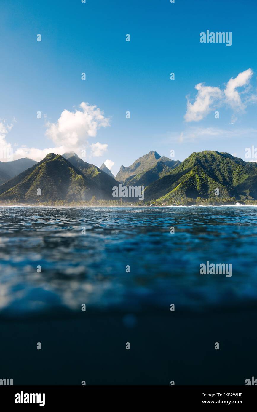 A serene view from the water at Teahupoo, showcasing the famous wave ...