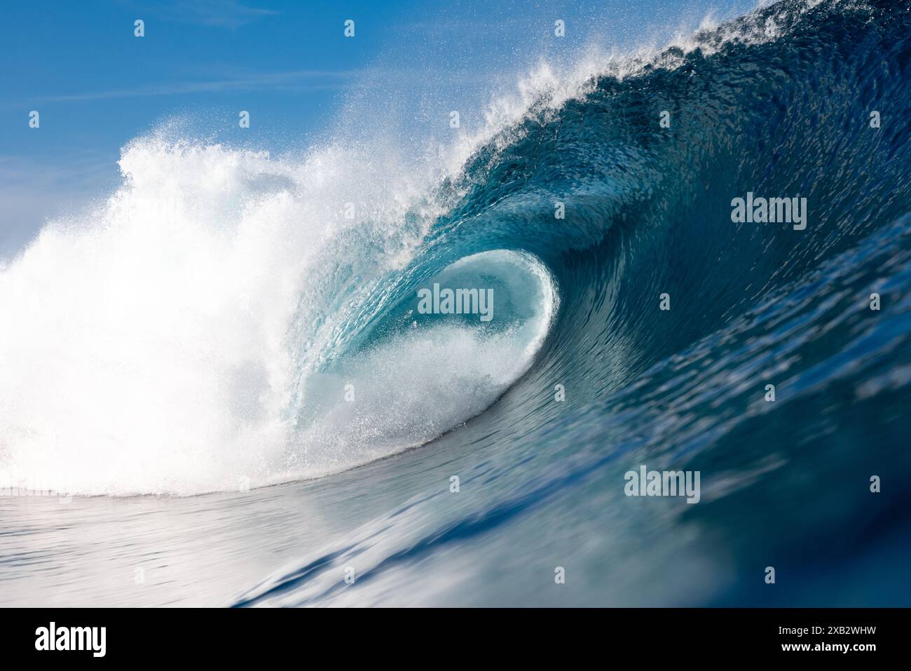 Crystalline barrel wave captured at the famous Teahupoo surf spot, with ...