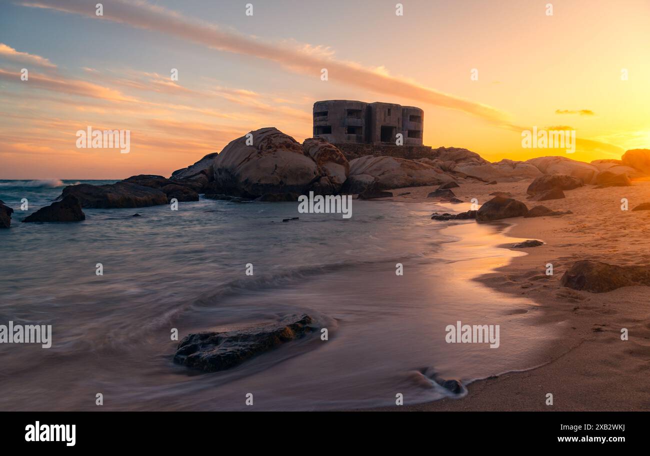 An abandoned World War II bunker at Atlanterra Beach set against a ...