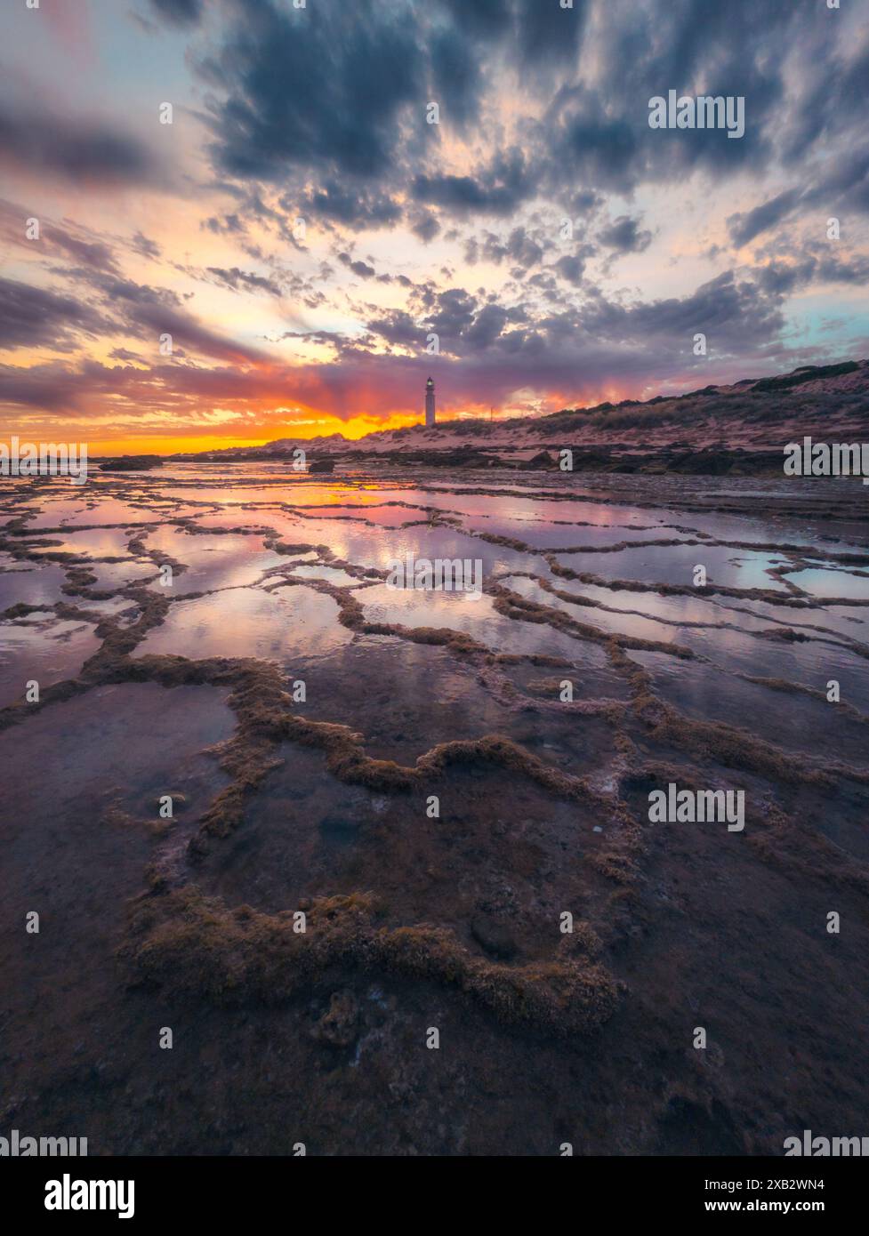 A breathtaking sunset over rocky tidal pools with the Trafalgar ...