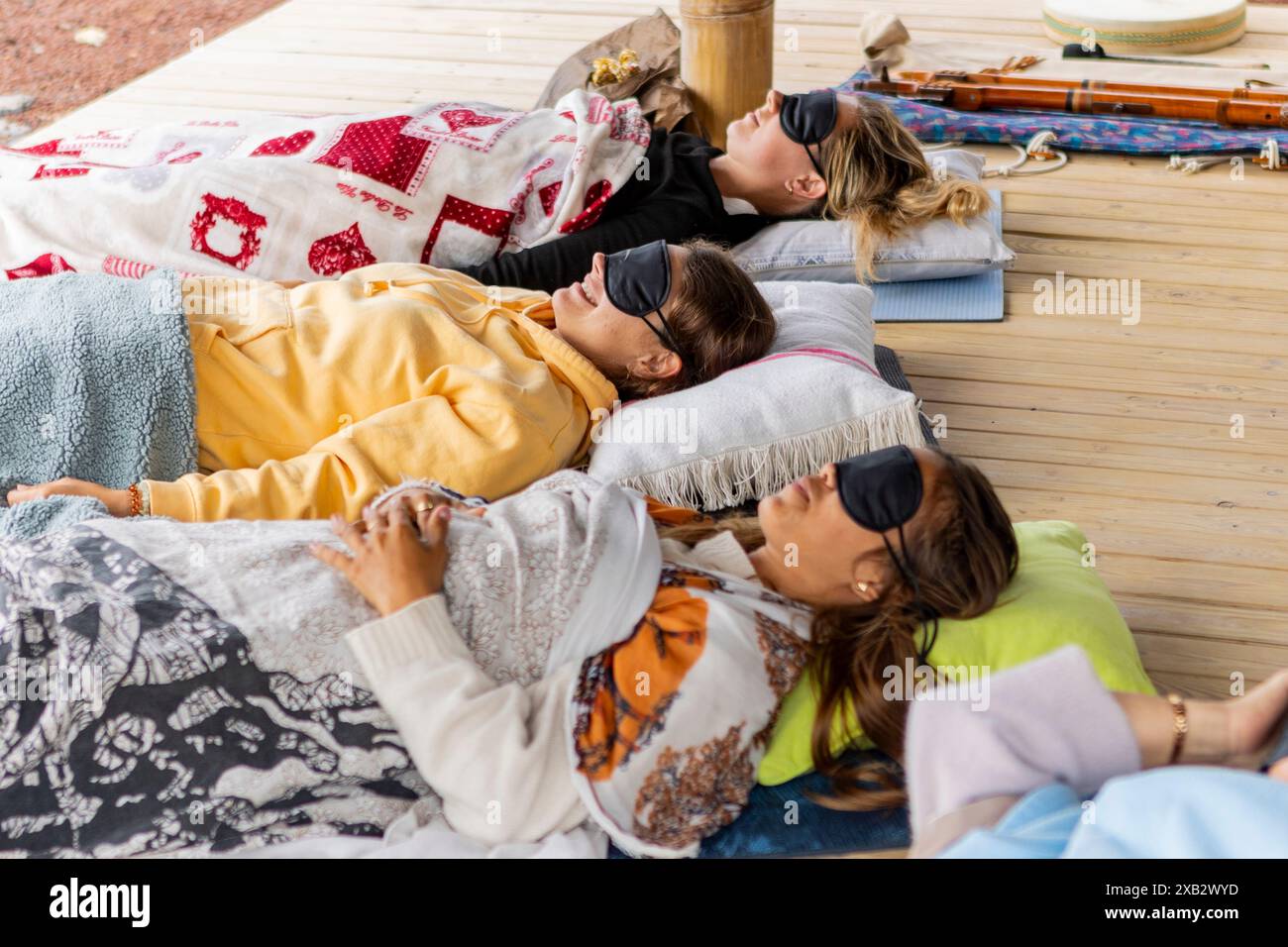 Three women partake in a mindfulness relaxation exercise with Tibetan ...