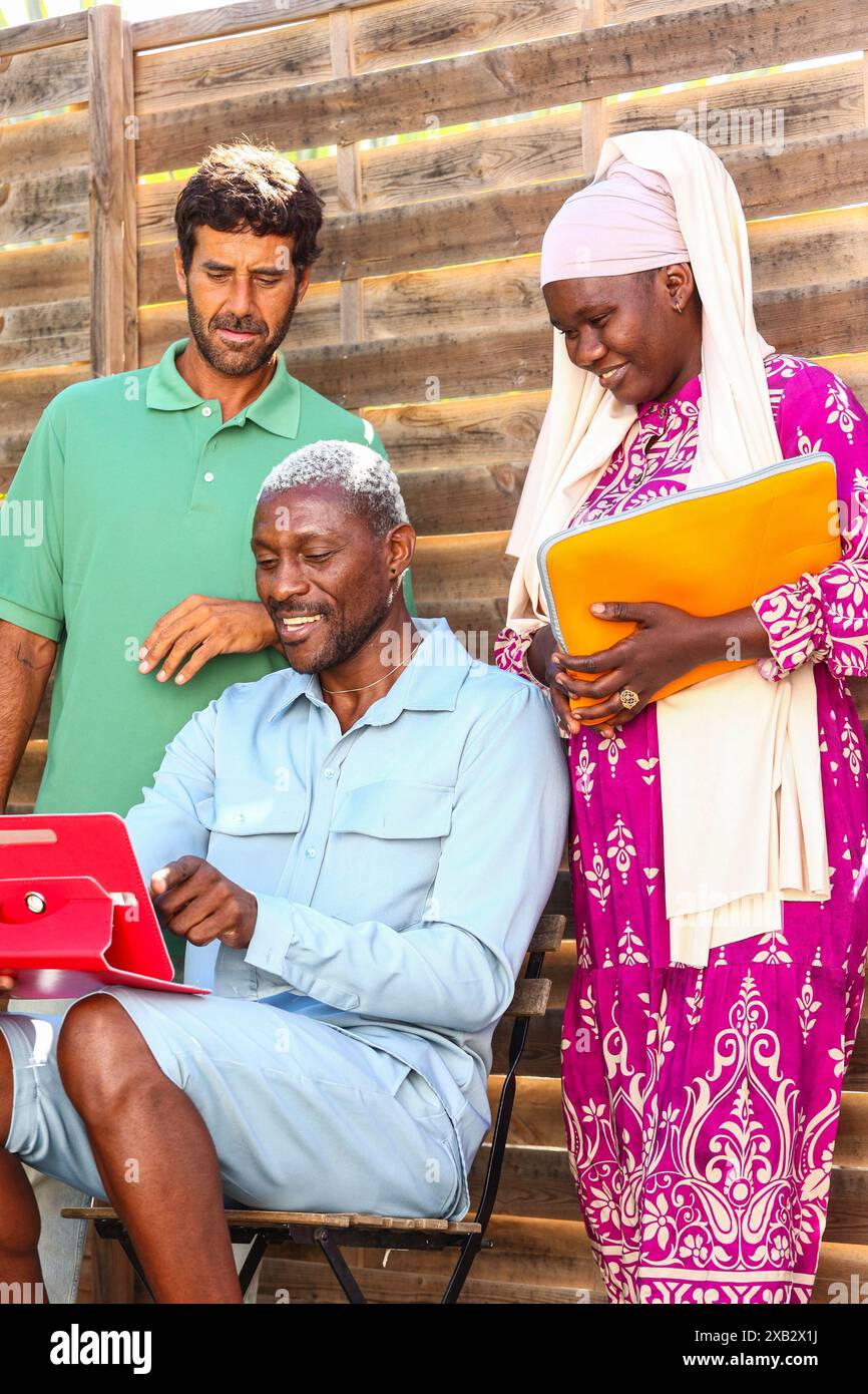 Multicultural friends share laughter during a sunny outdoor gathering ...