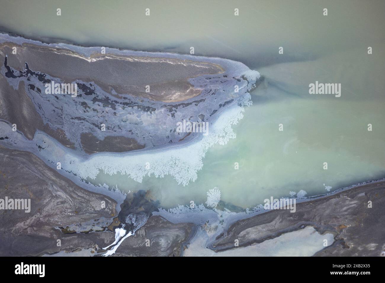 A top view capturing the intricate details of a partially frozen river ...