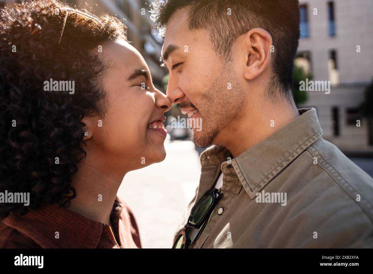 A loving couple, a Chinese man and a Hispanic woman, share a tender ...