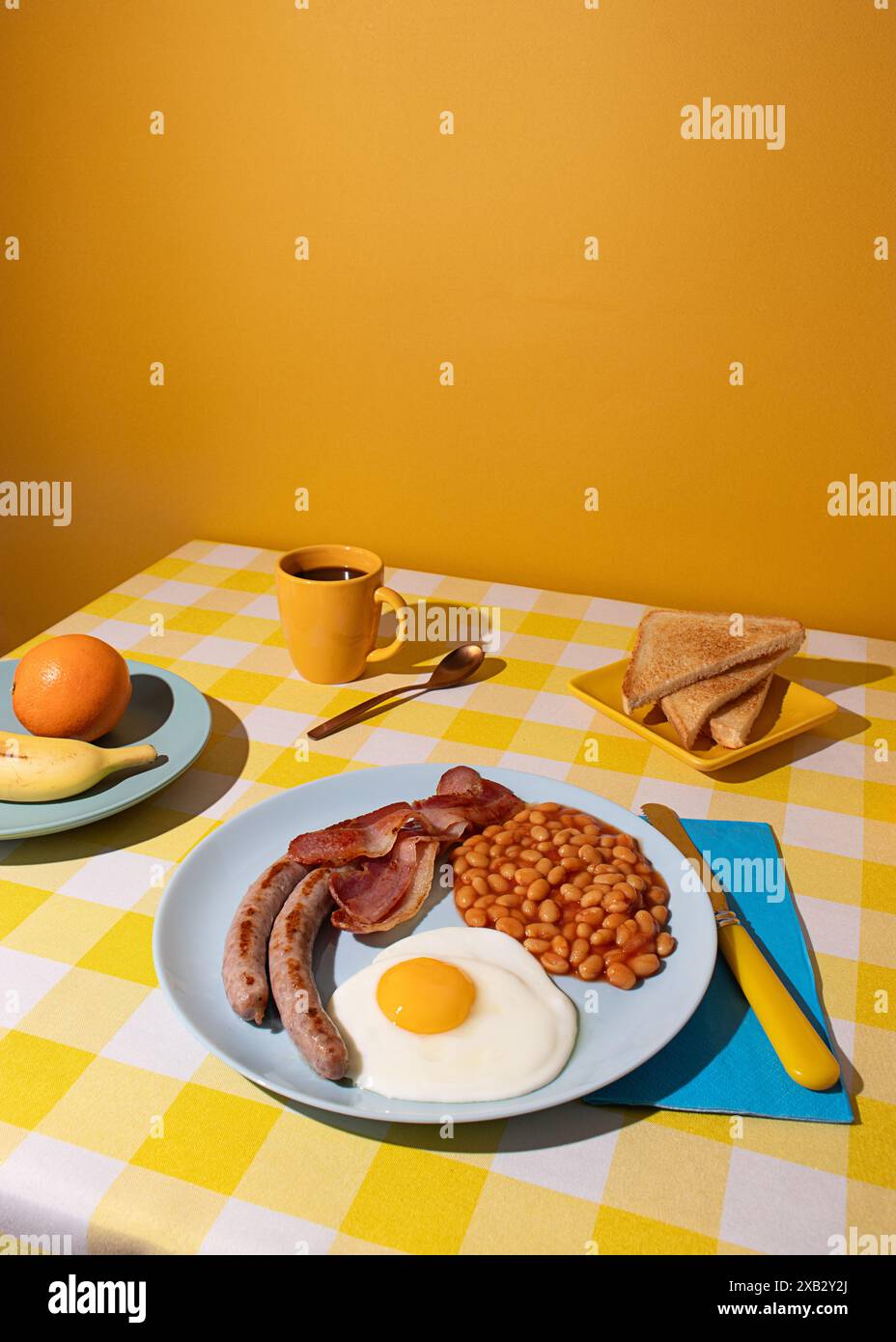 Yellow coloured Tablecloth and background with a delicious full English ...