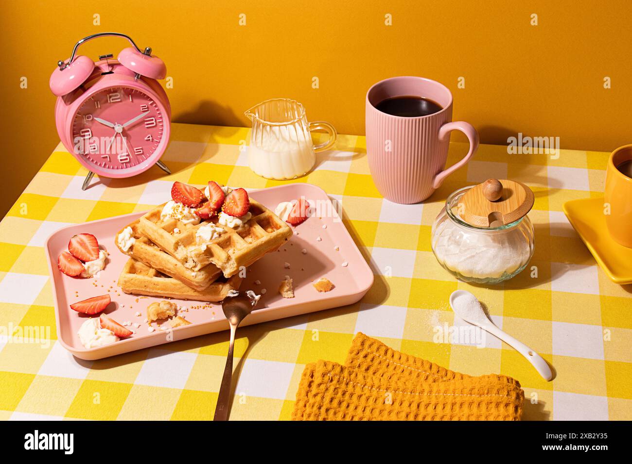 A delightful breakfast scene featuring a tray of crispy waffles topped ...