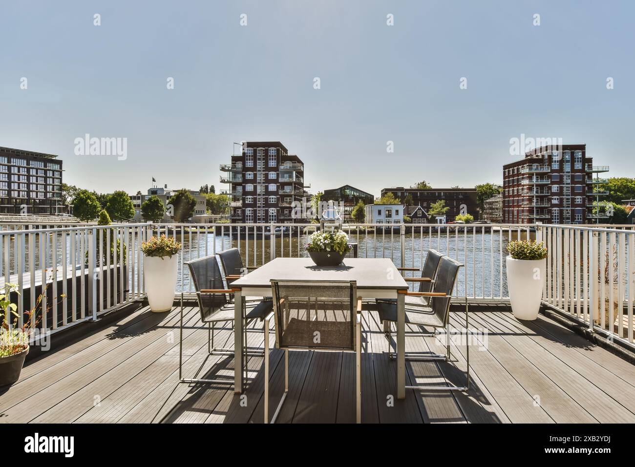 This image captures a stylish outdoor dining setup on a terrace in ...